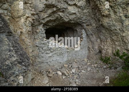 entrance to a small cave in the dolomites. Dolomites, Italy Stock Photo ...