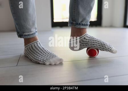 Myofascial relaxation of foot muscles with ball at home Stock Photo - Alamy