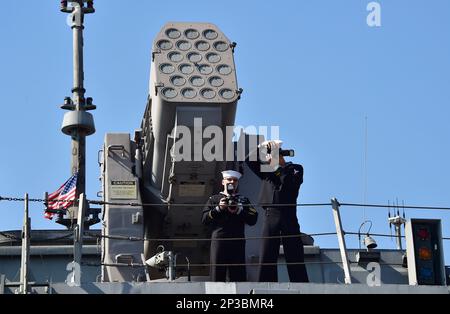 A rolling airframe missile (RAM) launcher fires a RIM-116 missile from ...