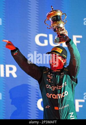 Third place Aston Martin's Fernando Alonso (bottom, second left ...