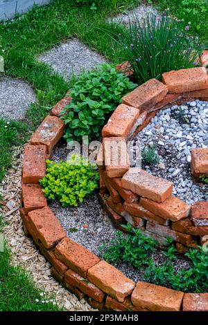 Brick circle for herbal garden Stock Photo - Alamy