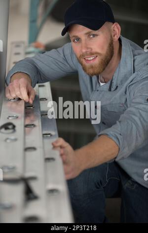maintenance worker man carrying aluminium step ladder Stock Photo - Alamy