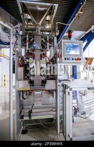 Coffee packaging, bagging and stacking machine Stock Photo - Alamy