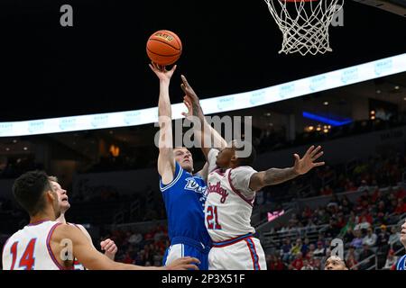 Drake guard Garrett Sturtz (3) shoots as Bradley guard Duke Deen, right ...