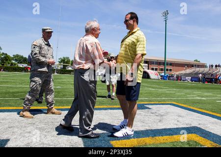 University of Michigan quarterback John Wangler is sacked by Daryle ...