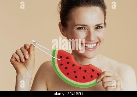 happy modern woman with watermelon shower sponge on beige background ...