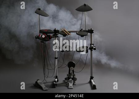 Modern electronic drum kit and smoke on dark background. Musical ...