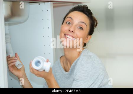 confident woman repairing sink in bathroom at home Stock Photo - Alamy