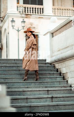 Brunette woman with hat and light beige dress on Ibiza pier Stock Photo ...