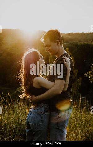 man and a woman hug in the park against sun in summer Stock Photo - Alamy