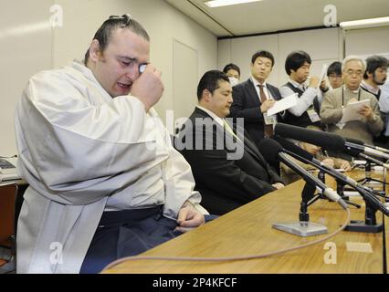 OSAKA, Japan - Bulgarian sumo wrestler Kotooshu (L) holds up a sumo ...