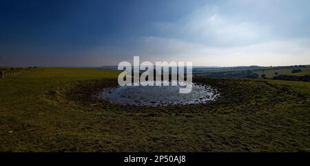 A Dew Pond on Ditchling Beacon in Sussex, with wispy clouds and a blue ...