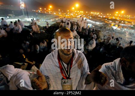 An Egyptian pilgrim prays on the rocky hill known as the Mountain of ...