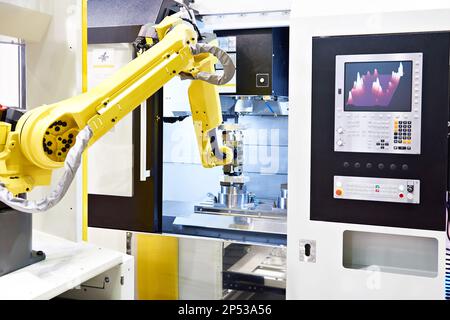 Robotic arm and vertical milling center with linear guides Stock Photo ...