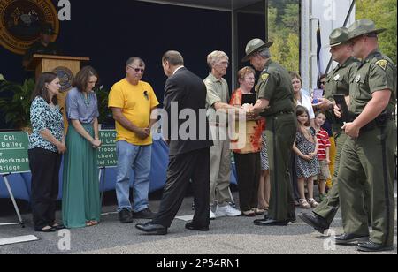 Gov. Earl Ray Tomblin and Col. Jay Smithers place a sign Thursday Sept ...