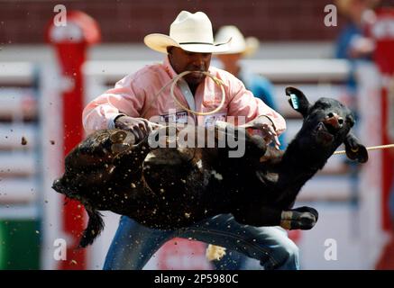 Cory Solomon of Prairie View, Texas comes off his horse in the tie-down ...