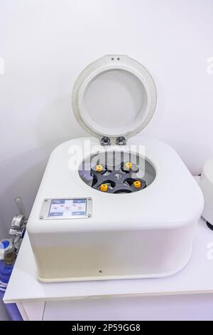 The blood tube is removed from the medical centrifuge for plasma ...