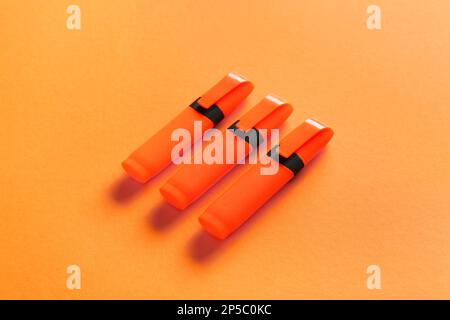 Permanent markers on orange background Stock Photo - Alamy