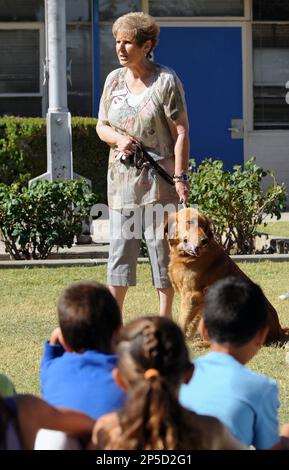 Alice Byrne Elementary School students pause during their recess to ...