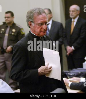 The Rev. Bill Langlois St. Patrick's Catholic Church receives a hug of ...