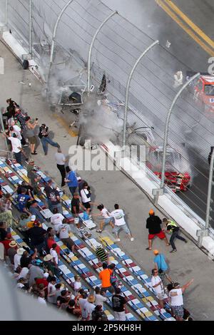 A horrific wreck of NASCAR driver Kyle Larson occurs with debris flying ...