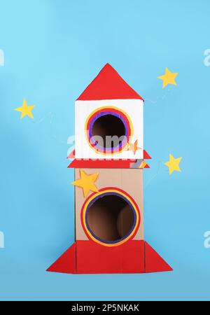 Cute handmade cardboard spaceship on light blue background Stock Photo ...