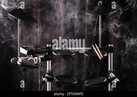 Modern electronic drum kit and smoke on grey background. Musical ...