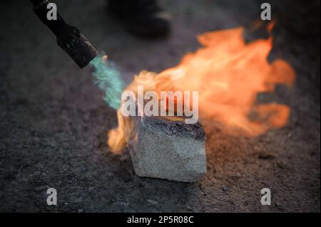 Coal on fire. Ignition of square coal with a gas burner Stock Photo - Alamy
