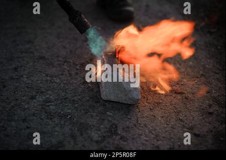 Coal on fire. Ignition of square coal with a gas burner Stock Photo - Alamy
