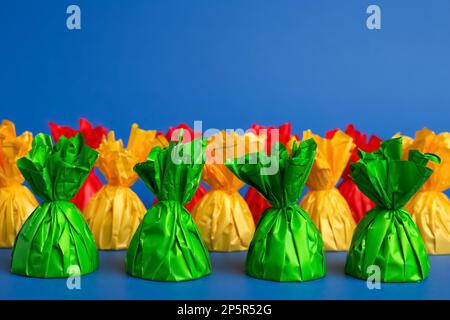 Candies in colorful wrappers on light blue background, flat lay Stock ...