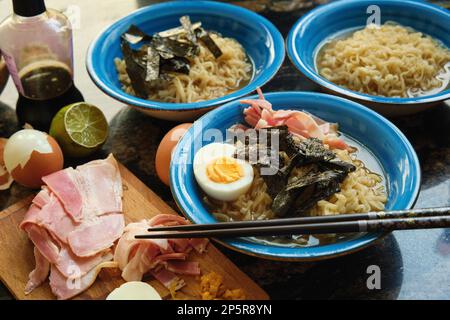 ramen soup in plates ingredients on the table Stock Photo - Alamy