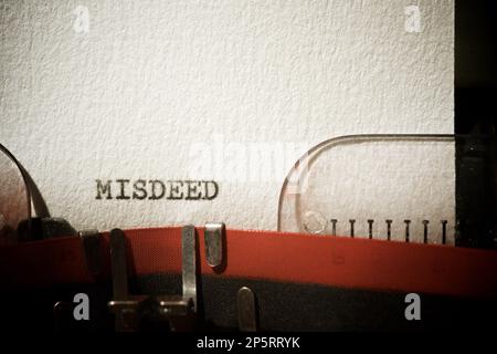 Misdeed word written with a typewriter Stock Photo - Alamy