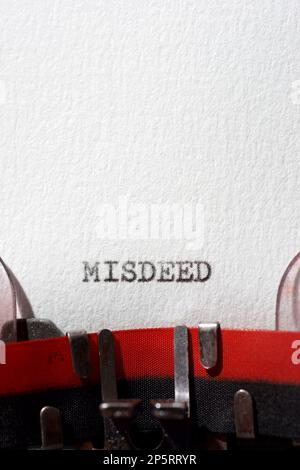 Misdeed word written with a typewriter Stock Photo - Alamy