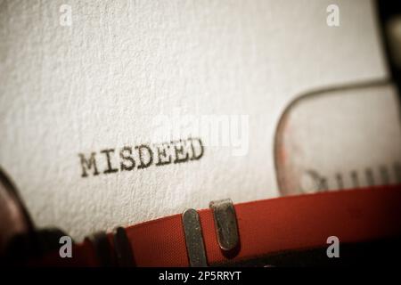 Misdeed word written with a typewriter Stock Photo - Alamy