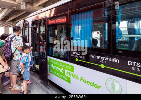 Passengers boarding electric shuttle bus at terminus, Bangkok, Thailand ...