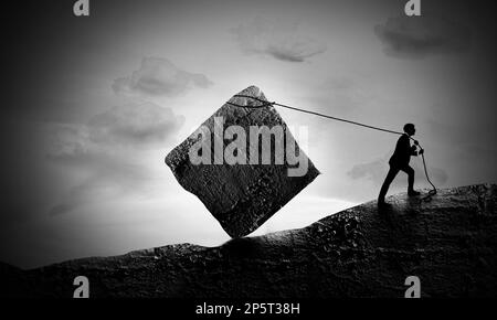 Man Pull Uphill A Big Rock With Chain In Front Of Sunset . Person male ...