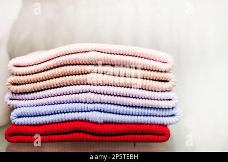 Multi-colored knitted hats and scarves on mannequins. Soft and ...