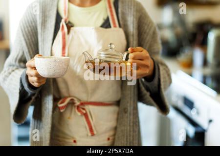 cropped view of woman pouring tea to cup at morning Stock Photo - Alamy
