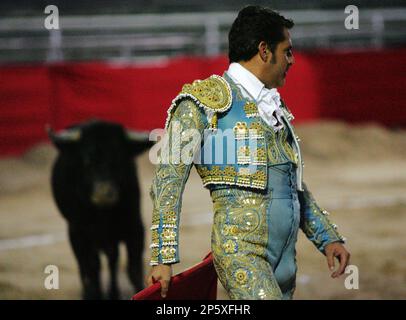 Professional bullfighter Manolo Martinez Jr. tames a bull during a ...