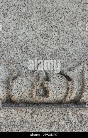 A repeating pattern carved into the natural stone wall Stock Photo - Alamy