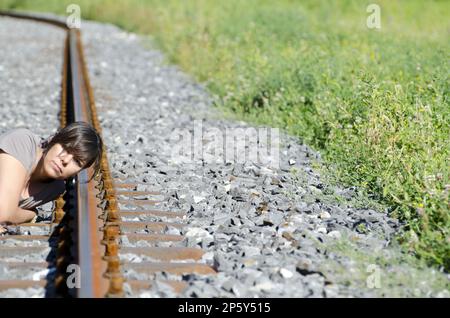 Woman Listening for a Incoming Train on the Railroad Track Stock Photo ...