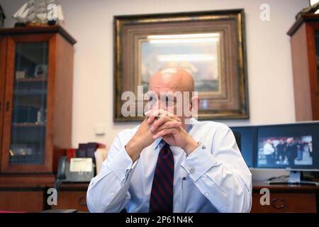 Clark County Coroner Michael Murphy takes what appear to be flowers ...