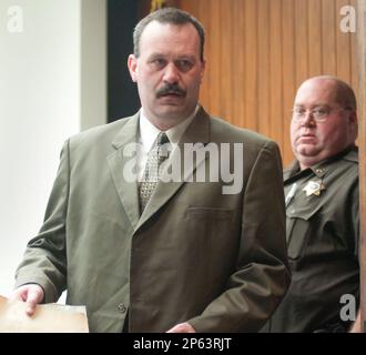 Michigan State Police Lt. Jason Teddy scrolls through text messages ...