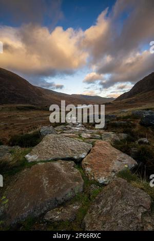 Stone footpath leading towards mountains Stock Photo - Alamy