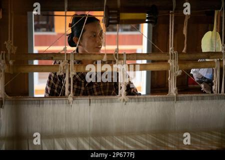 Burmese woman working on loom at workshop, Lake Inle, Shan State ...