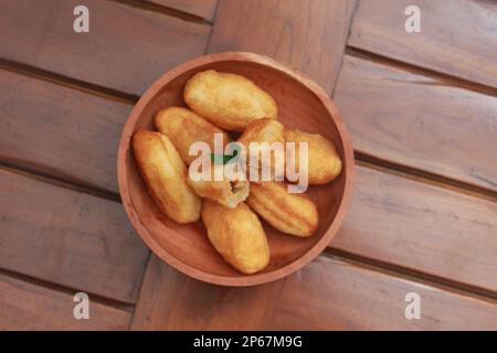 Comro or combro, a traditional Javanese snack made of deep fried grated ...