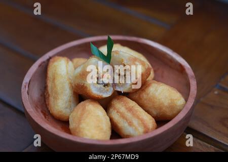 Comro or combro, a traditional Javanese snack made of deep fried grated ...