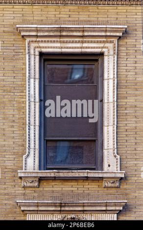White terra cotta decorates the features of this tan roman brick ...