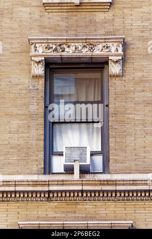 White terra cotta decorates the features of this tan roman brick ...