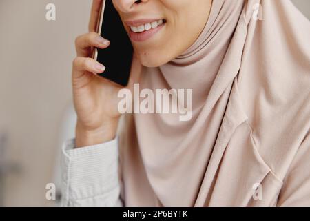 Cropped image of young woman making appointment on the phone and ...